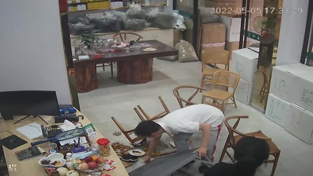 Teenager tries sliding chair under table but knocks over all the food ...