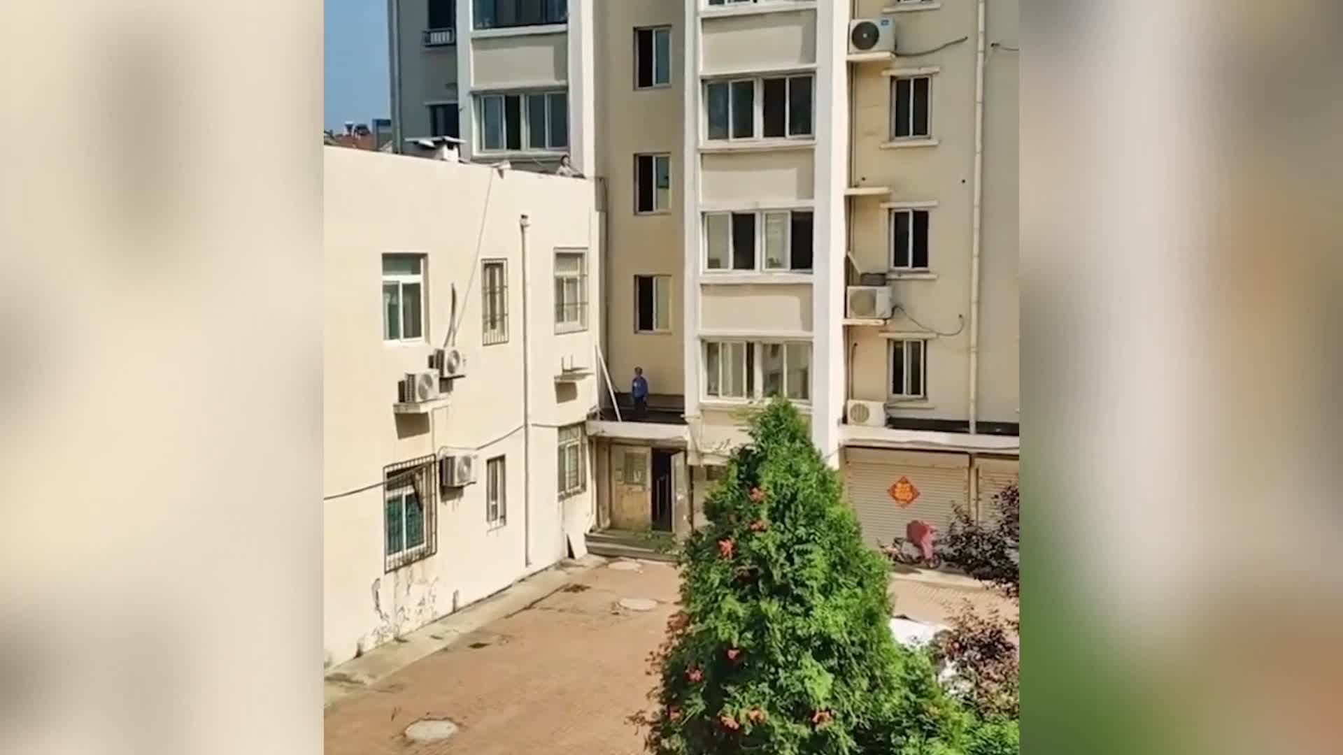 Concerned neighbour scolds children playing on building's unfenced ...
