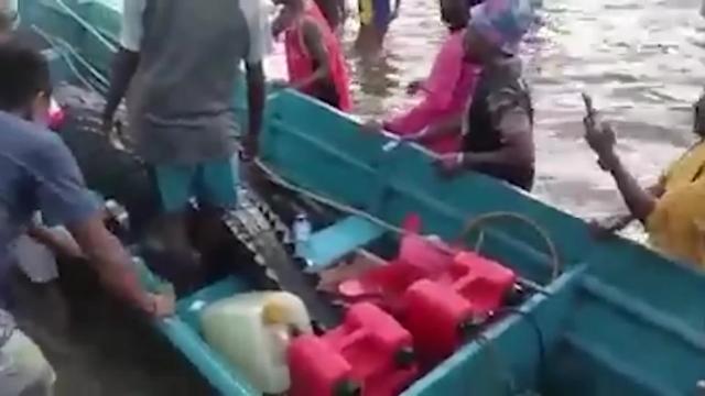 Angry villagers pull missing neighbour's body from giant crocodile's ...
