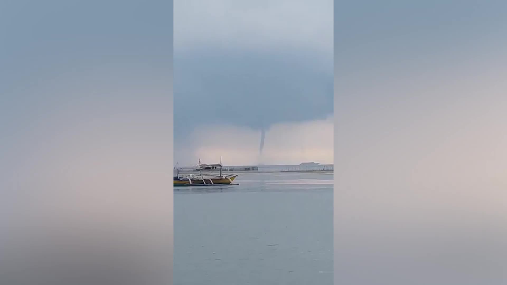 Large waterspout forms next to fishing boats in the Philippines ...