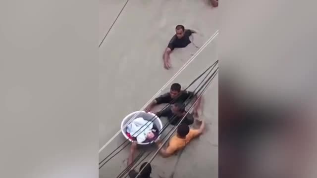 Baby floated to safety in a basin during Cyclone Remal floods in India ...