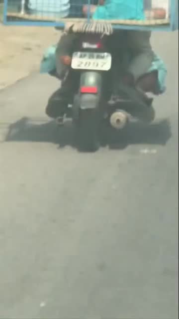 Father seen carrying sons in cage on the back of motorcycle - ViralPress